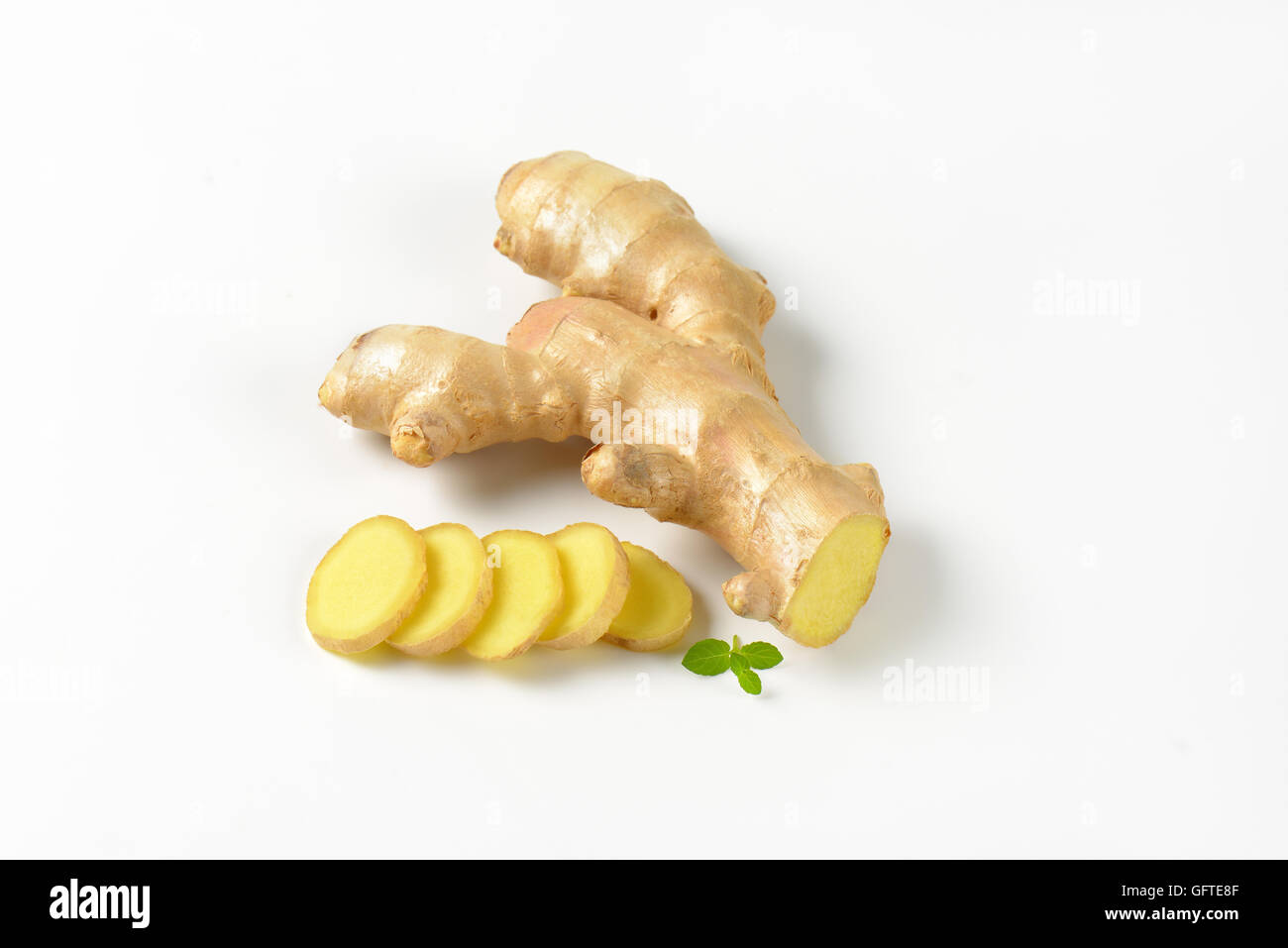 sliced fresh ginger on white background Stock Photo - Alamy