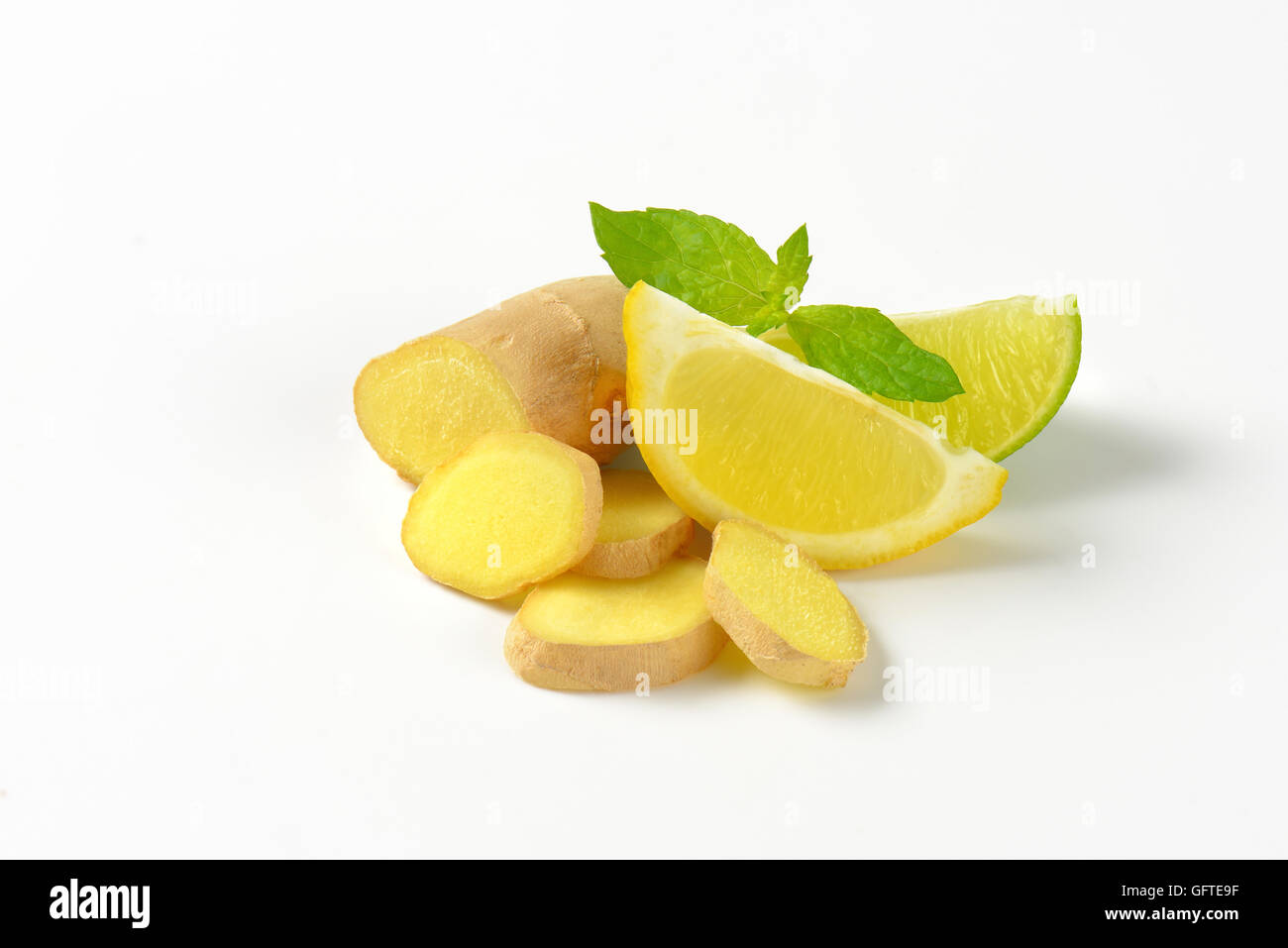 sliced ginger with lemon and lime on white background Stock Photo - Alamy