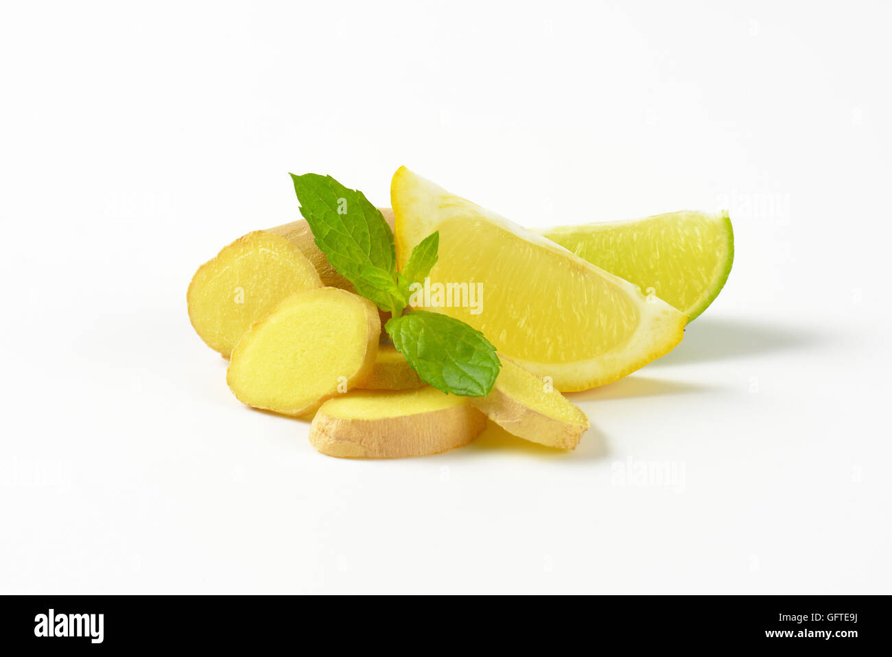 sliced ginger with lemon and lime on white background Stock Photo - Alamy