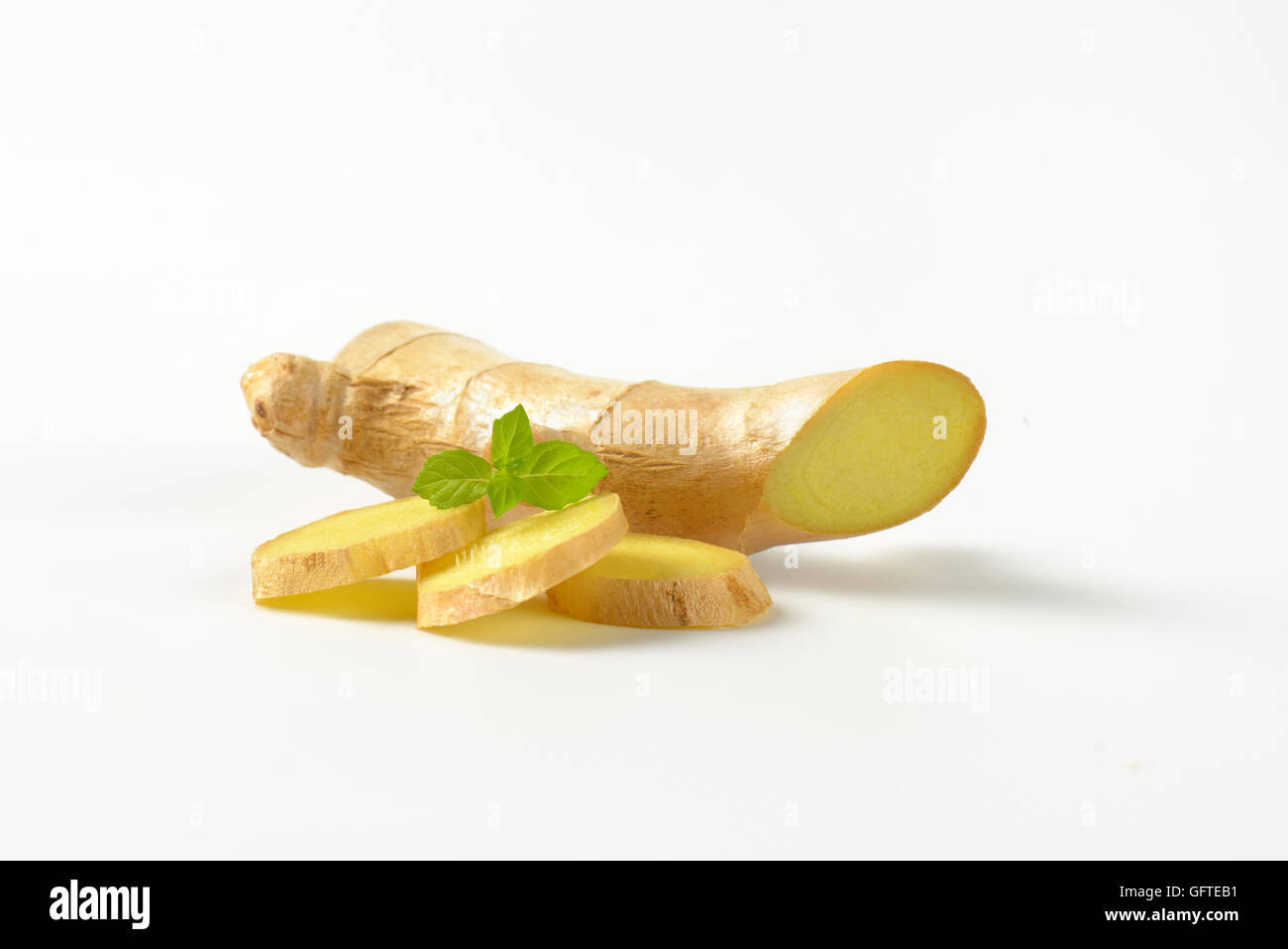 sliced ginger root on white background Stock Photo - Alamy