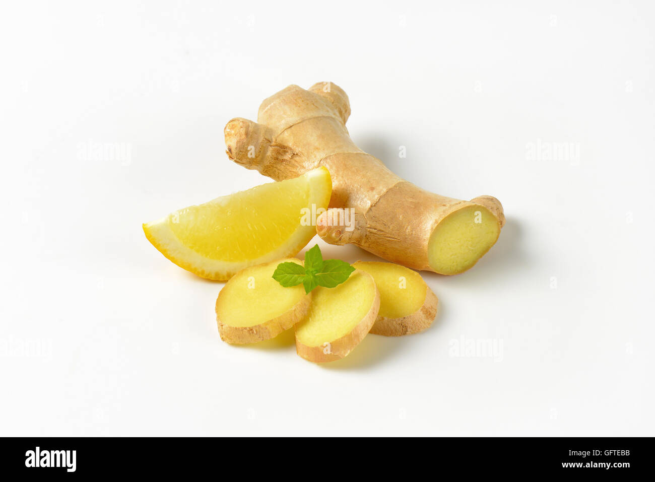 sliced ginger with lemon on white background Stock Photo - Alamy