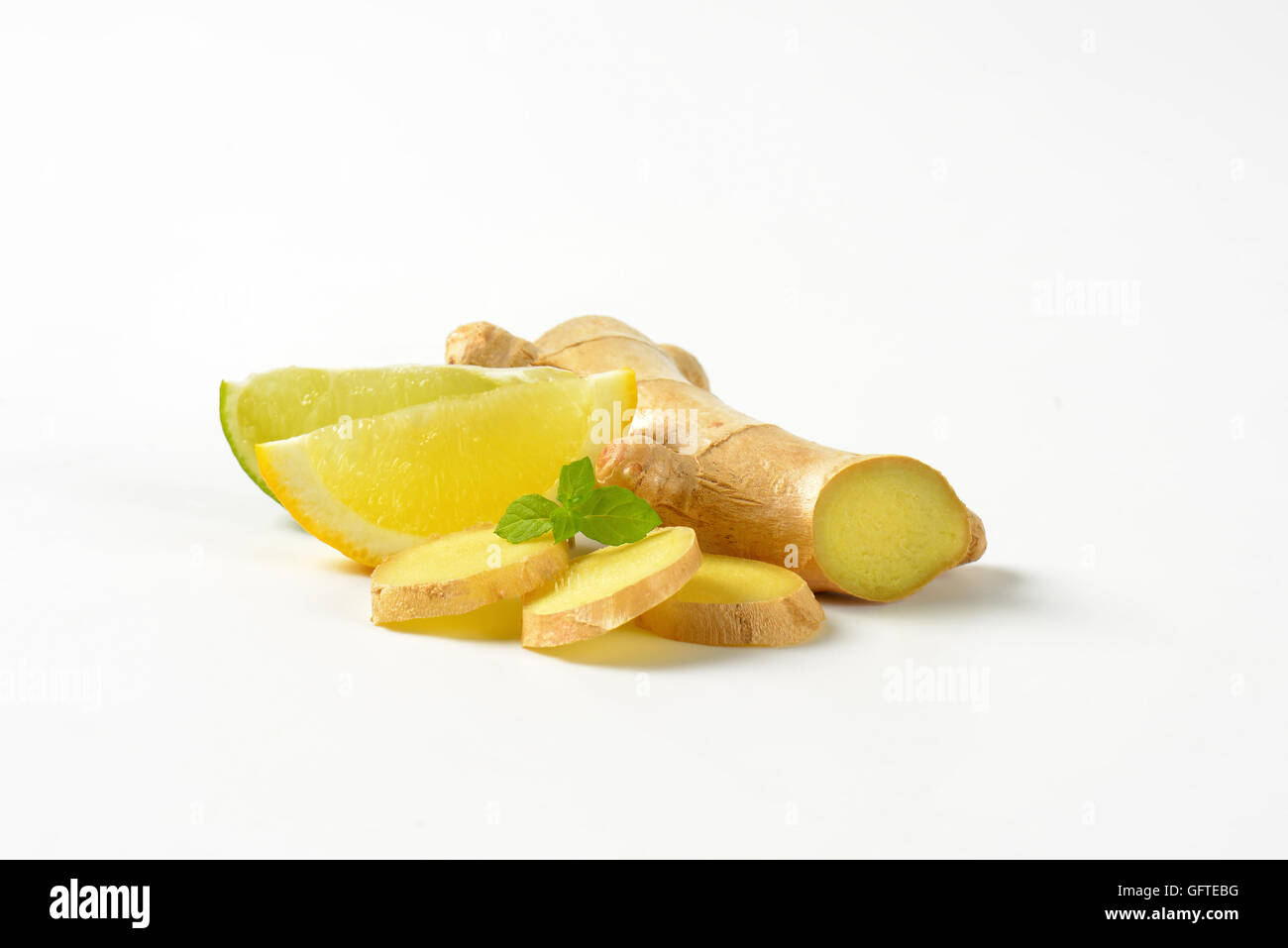 sliced ginger with lemon and lime on white background Stock Photo - Alamy