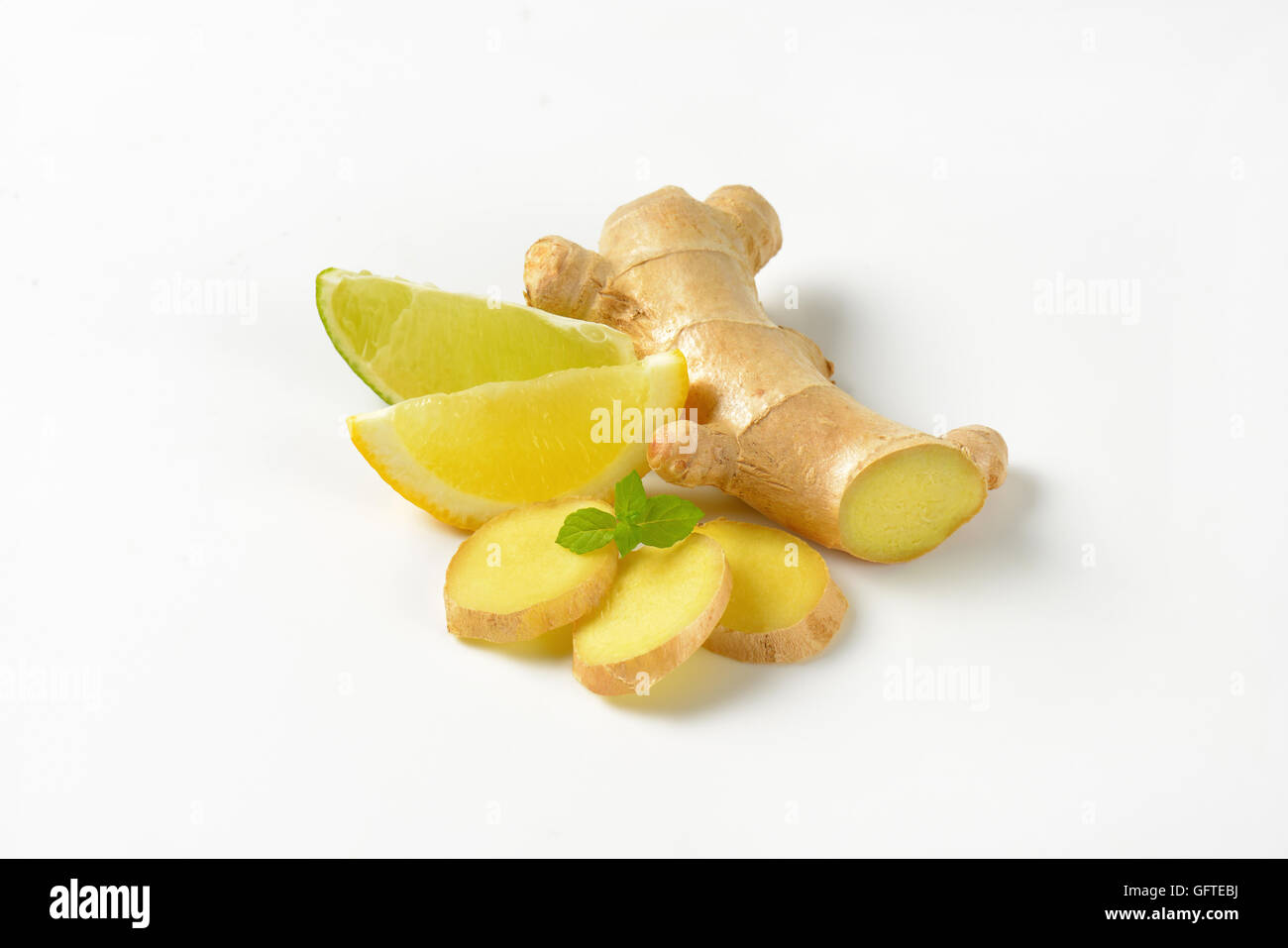 sliced ginger with lemon and lime on white background Stock Photo - Alamy