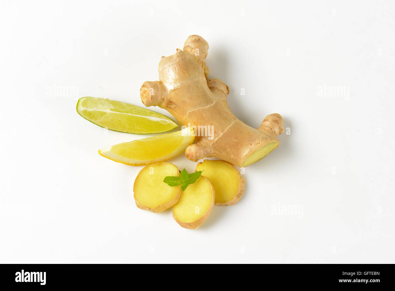sliced ginger with lemon and lime on white background Stock Photo - Alamy