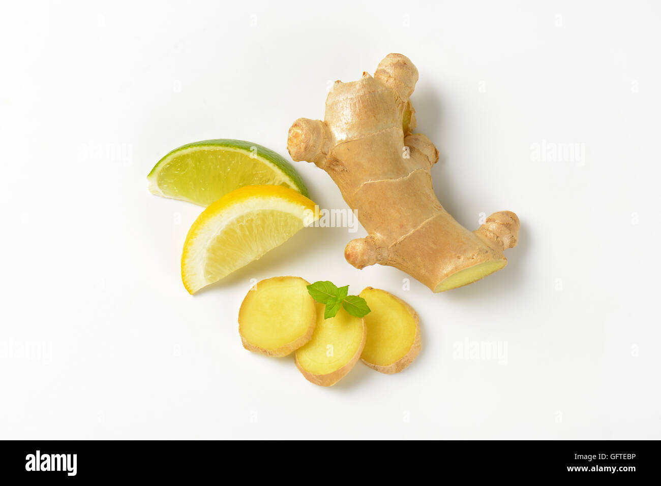 sliced ginger with lemon and lime on white background Stock Photo - Alamy