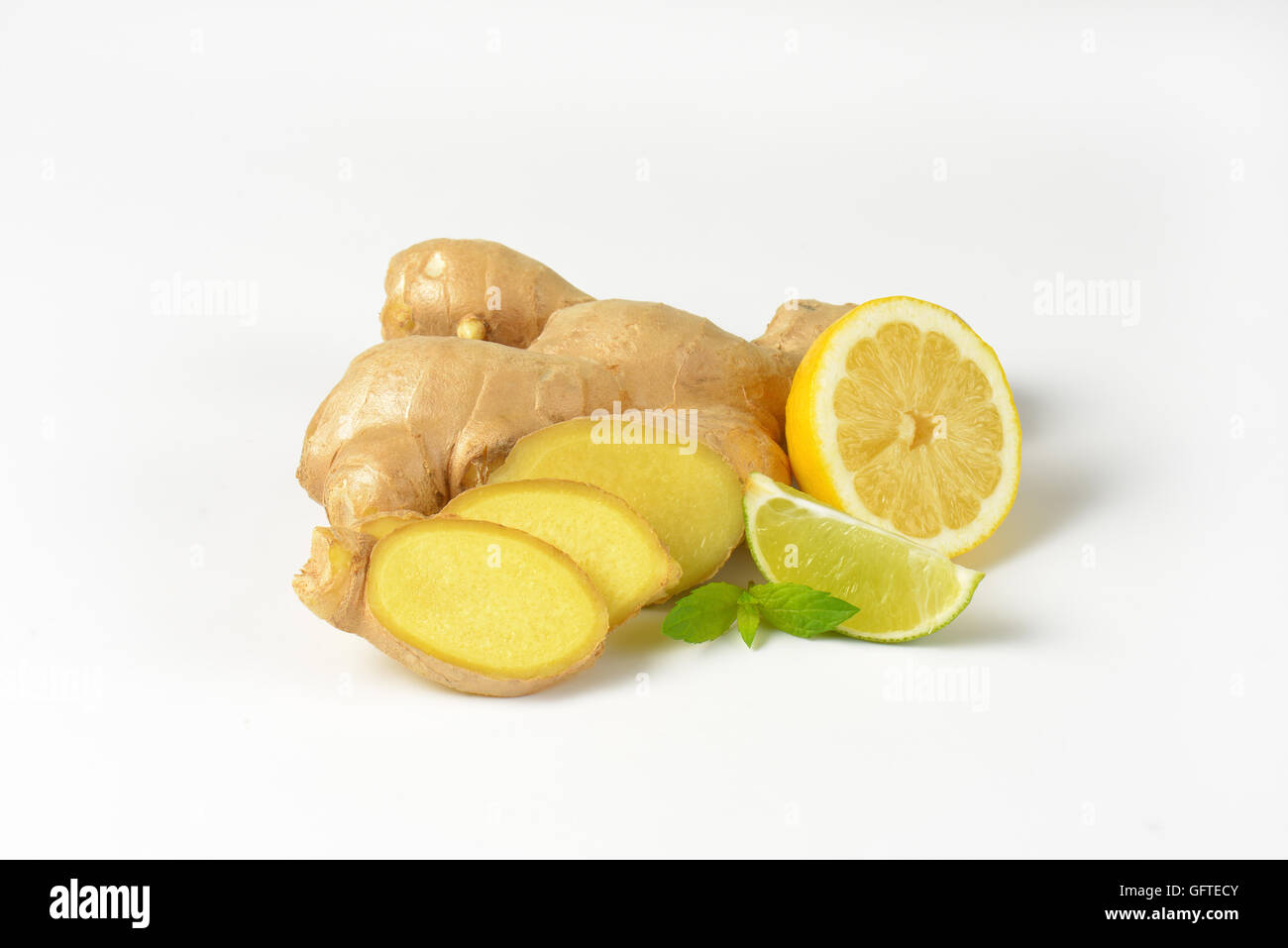 sliced ginger with lemon and lime on white background Stock Photo - Alamy