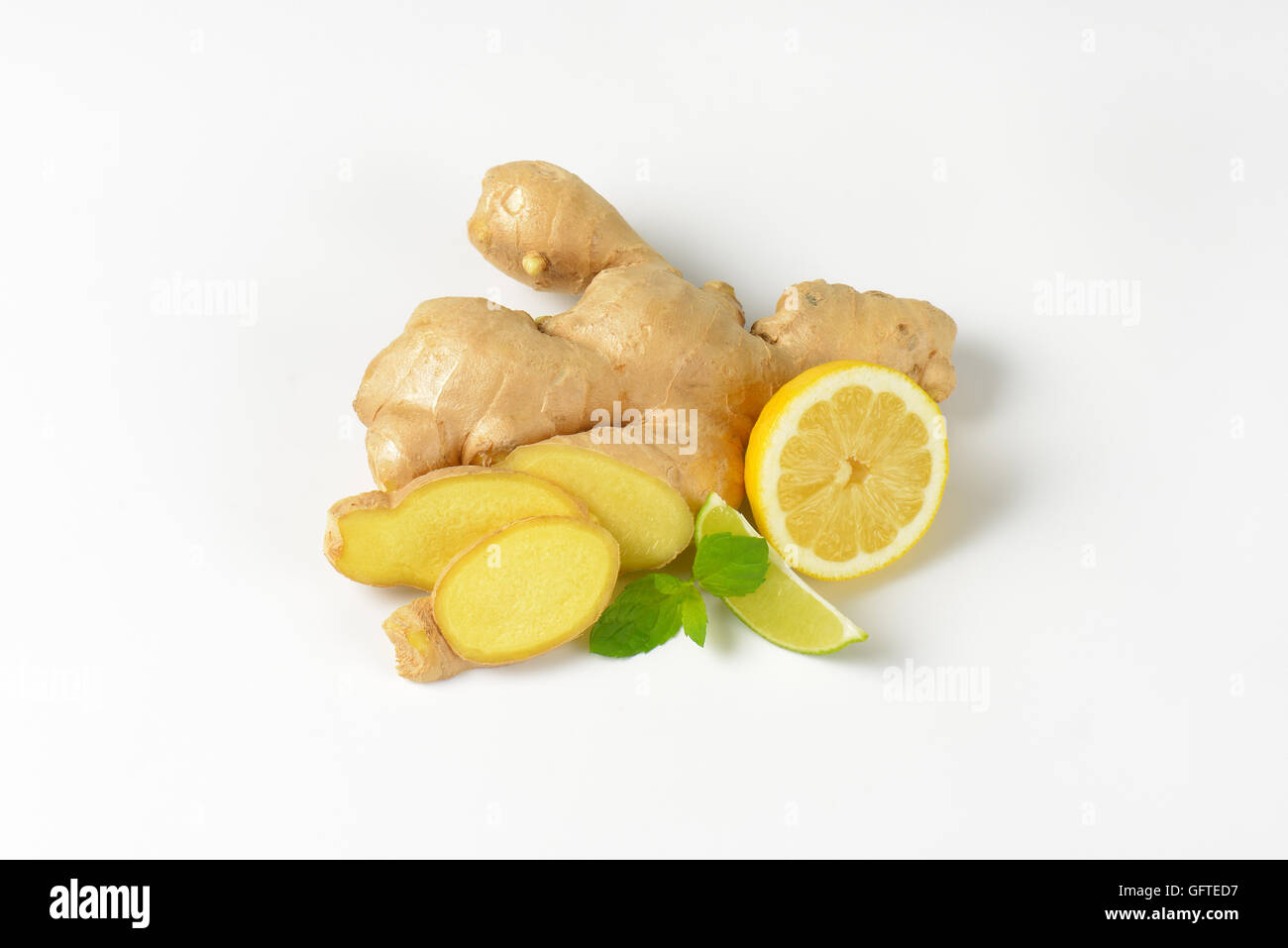 sliced ginger with lemon and lime on white background Stock Photo - Alamy