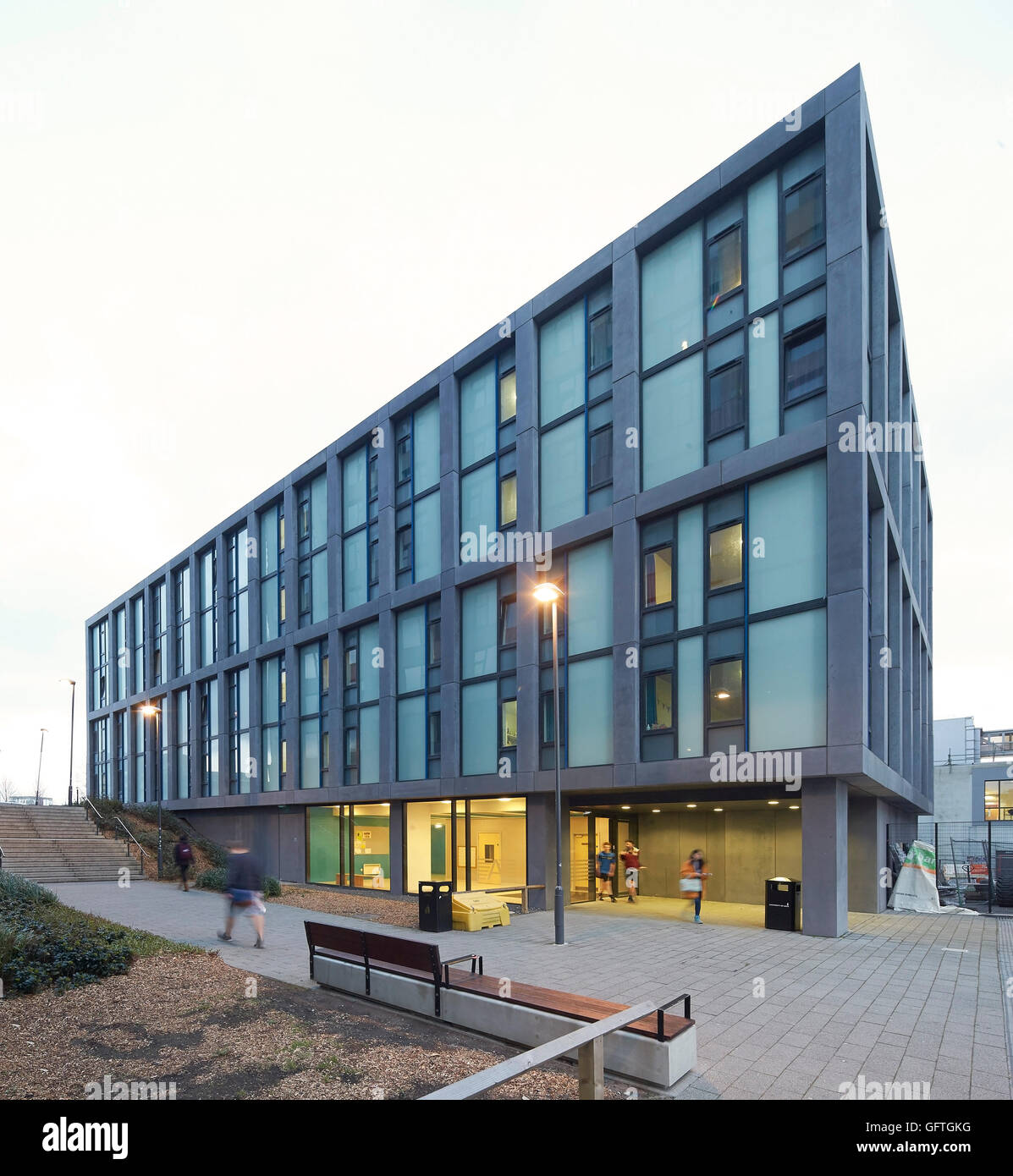 Landscaped walkway with lit up main entrance. Leeds Central Village ...
