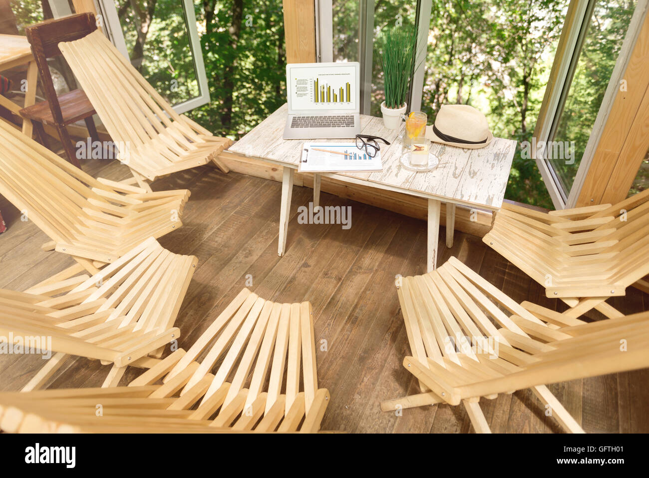 Chairs standing around the table Stock Photo - Alamy
