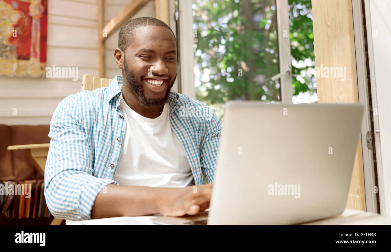 Joyful man sitting table hi-res stock photography and images - Alamy