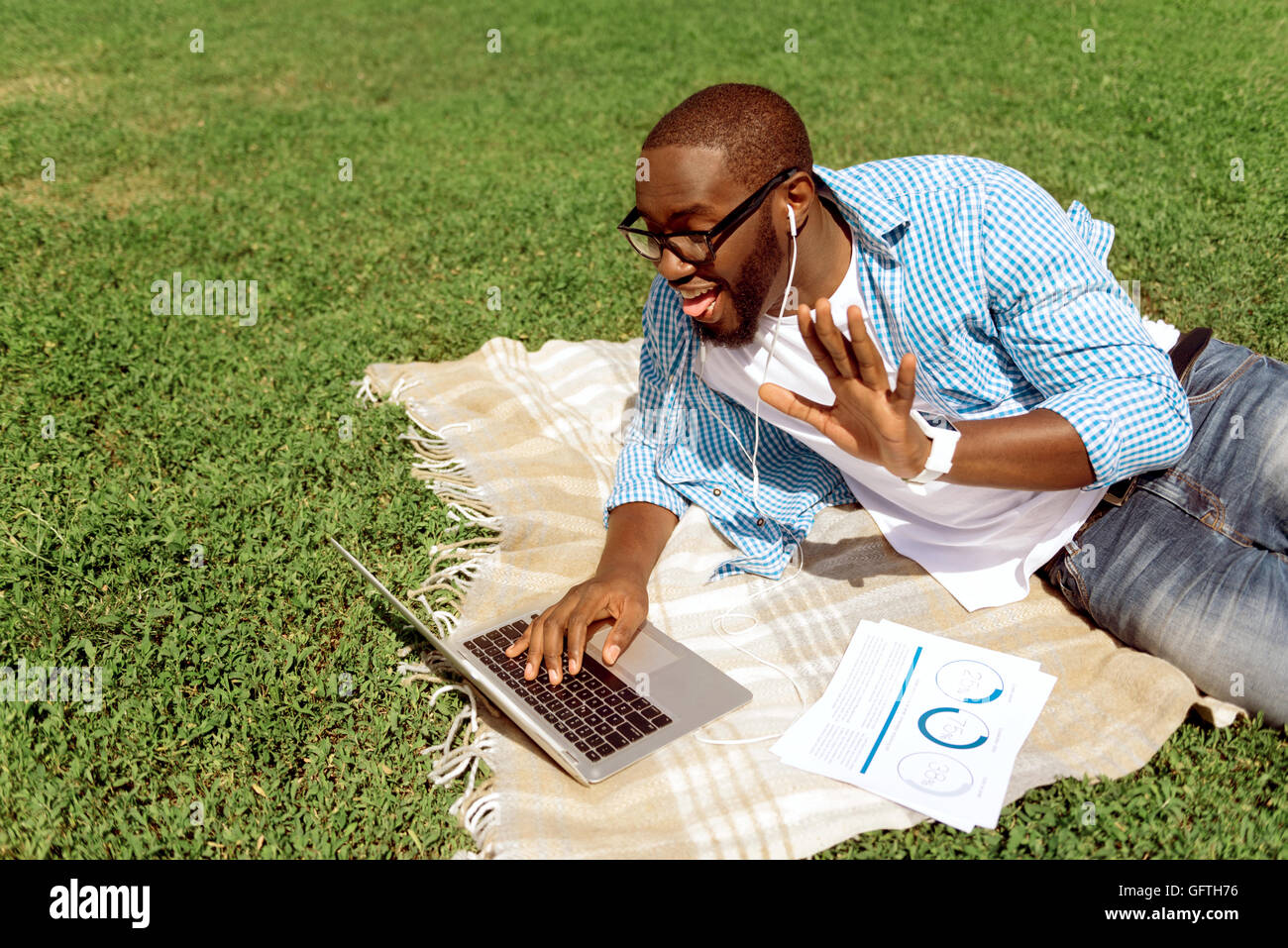 Cheerful man using laptop Stock Photo - Alamy