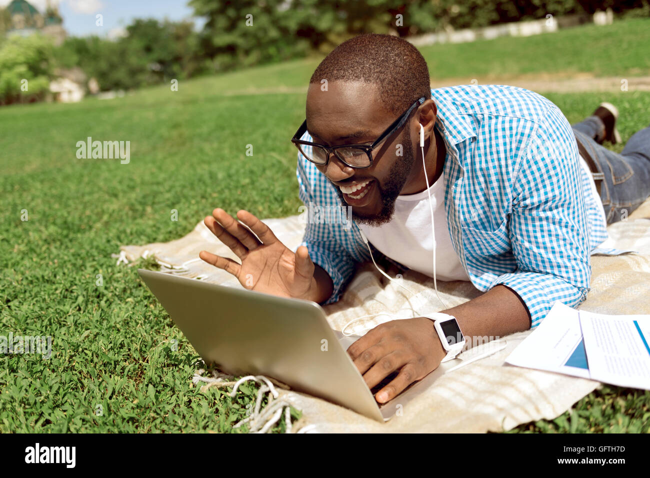 Positive smiling man talking through the Internet Stock Photo - Alamy
