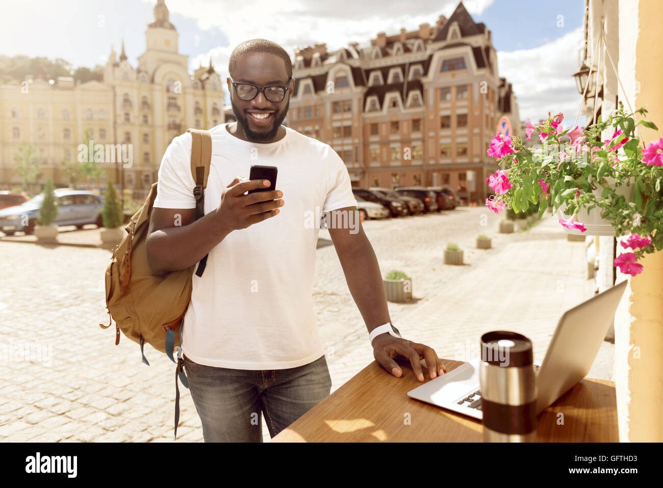 Cheerful man using cell phone Stock Photo - Alamy