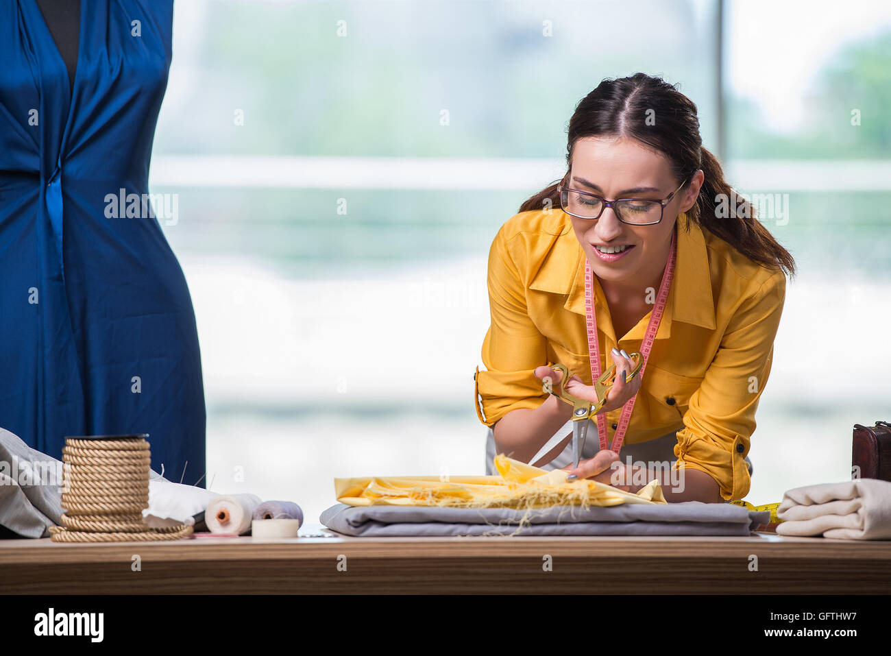 Woman tailor working on new clothing Stock Photo - Alamy