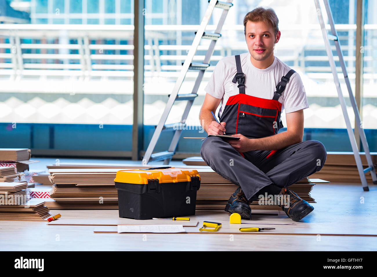 Man laying laminate flooring in construction concept Stock Photo - Alamy