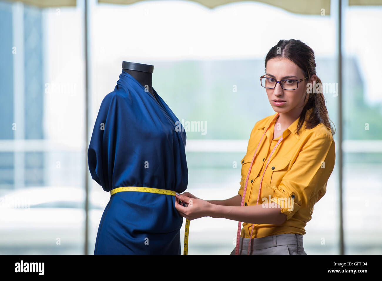 Woman tailor working on new clothing Stock Photo - Alamy