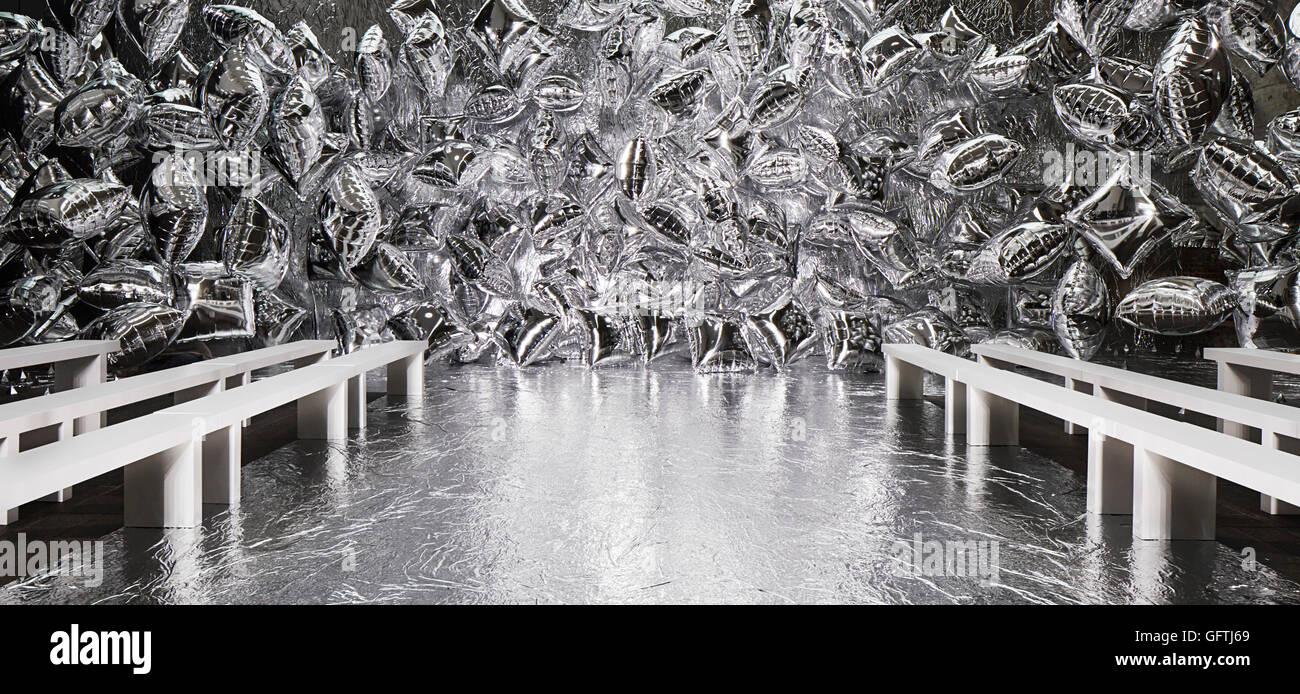 Fashion show runway with benches and sculptural backdrop. Central Saint ...