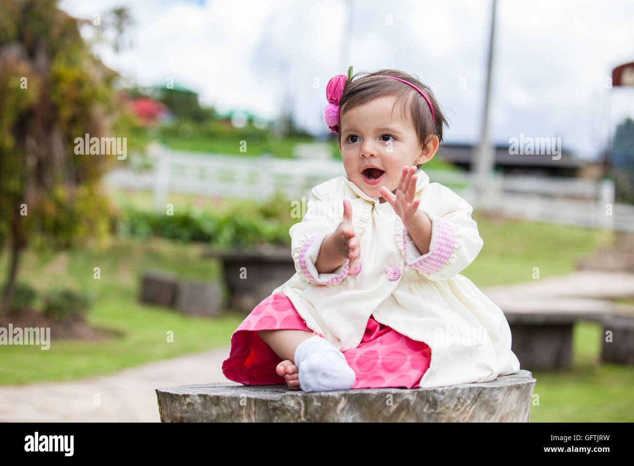 Little baby girl singing happy outdoors Stock Photo - Alamy