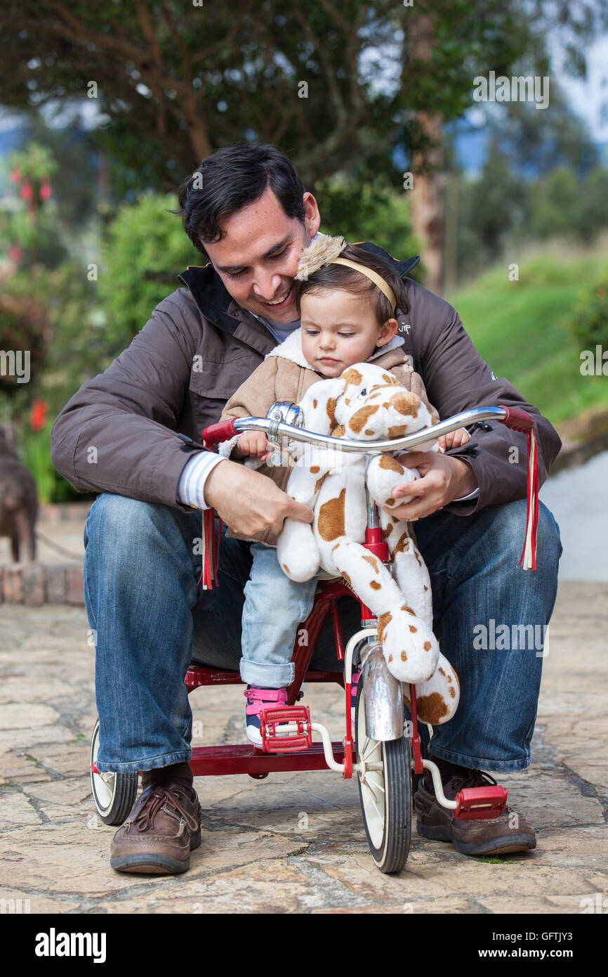With dad riding my tricycle Stock Photo - Alamy