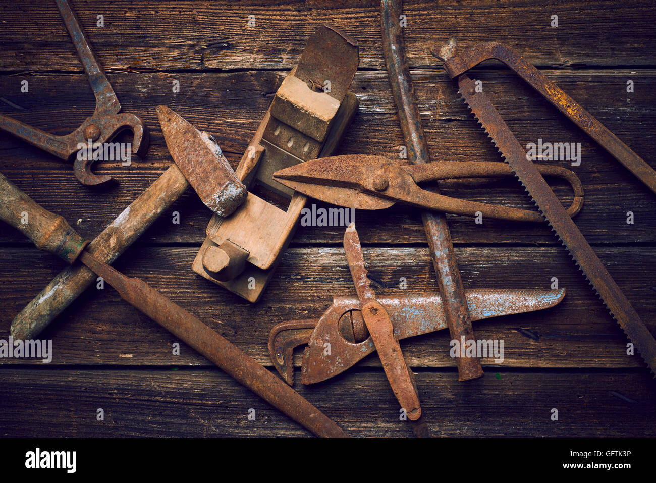 Grungy old rusted tools on a wooden background (processing cross ...