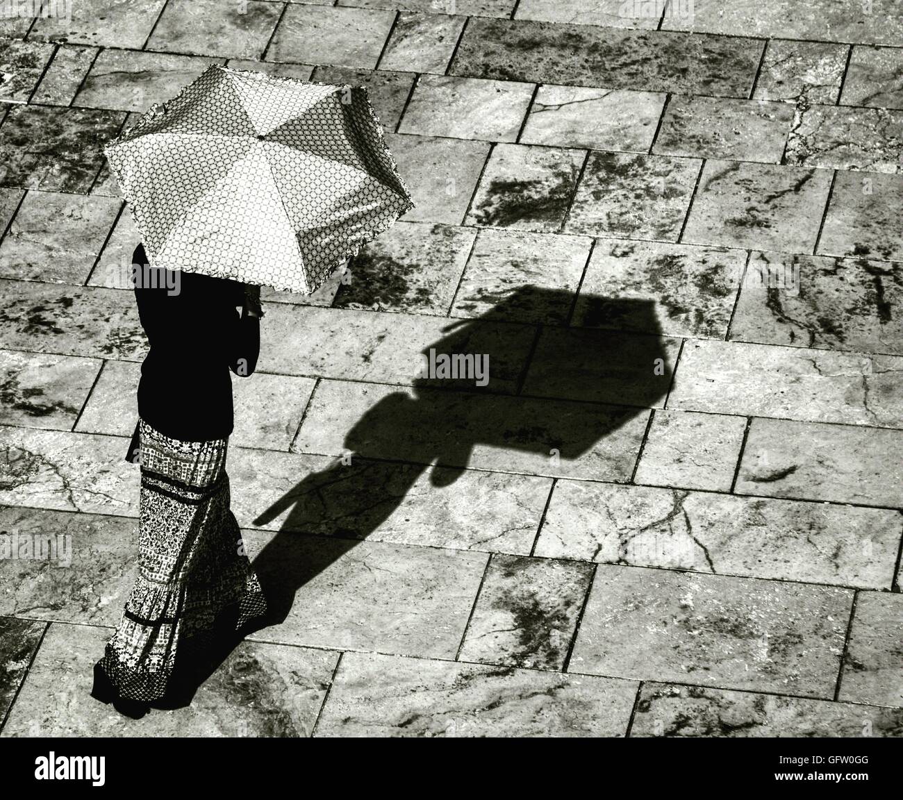 woman walking under the sun with an umbrella Stock Photo - Alamy