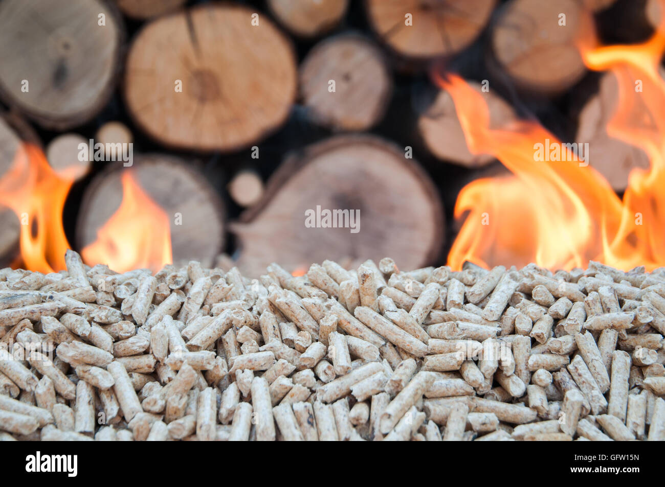 Burning Oak pellets in front a pile of woods Stock Photo - Alamy