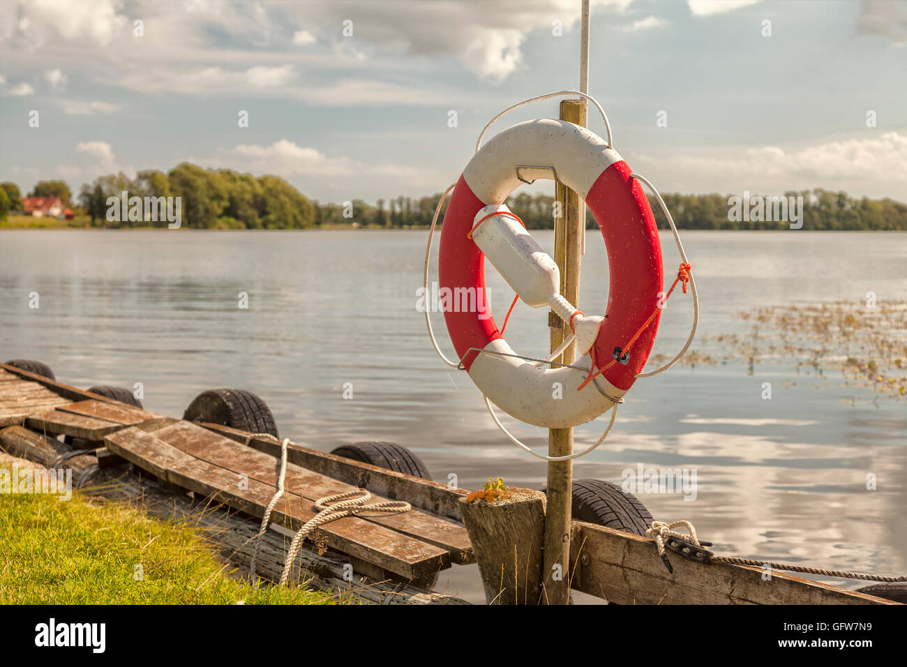 Image of life ring hanging by the lake shore Stock Photo - Alamy
