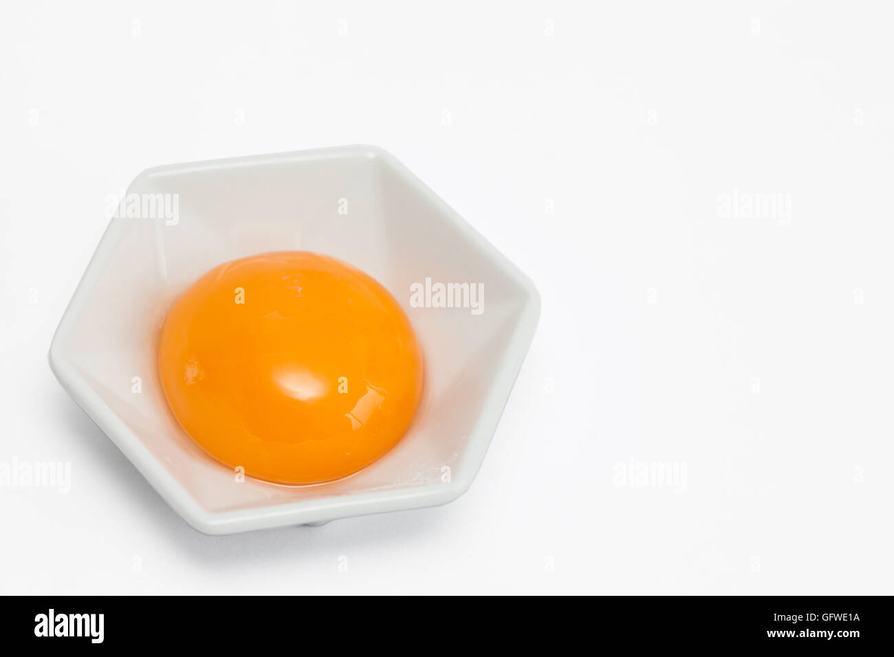 Egg yolk in white background Stock Photo - Alamy