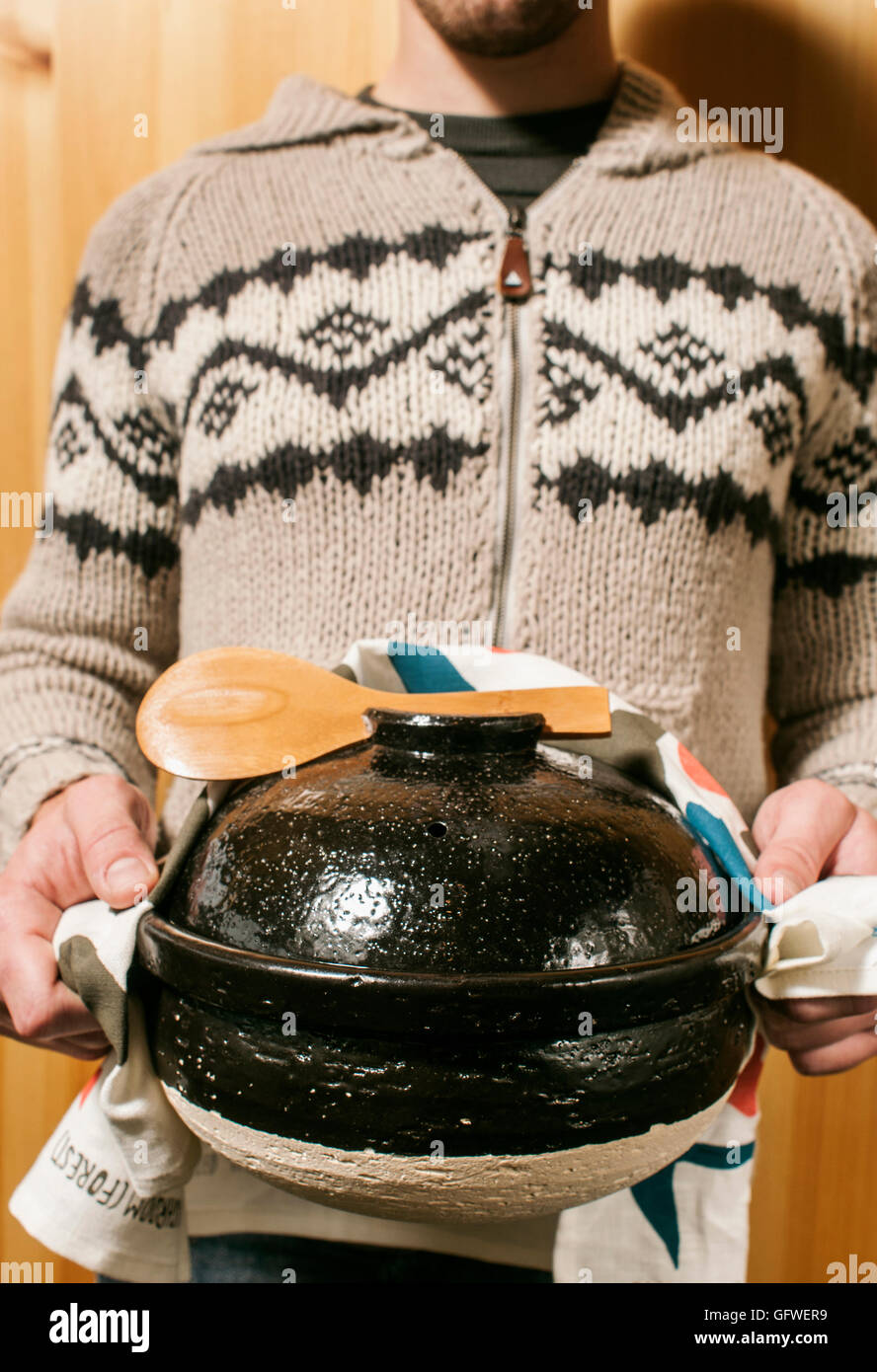 An unidentifiable man holding a crock pot Stock Photo - Alamy