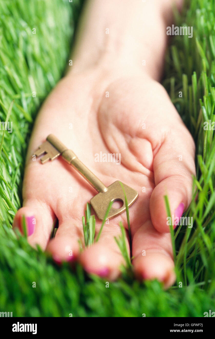 A woman's hand holding a key Stock Photo - Alamy