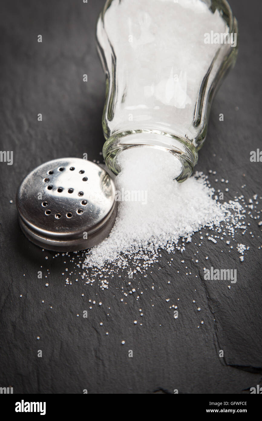 Salt shaker on slate board Stock Photo - Alamy
