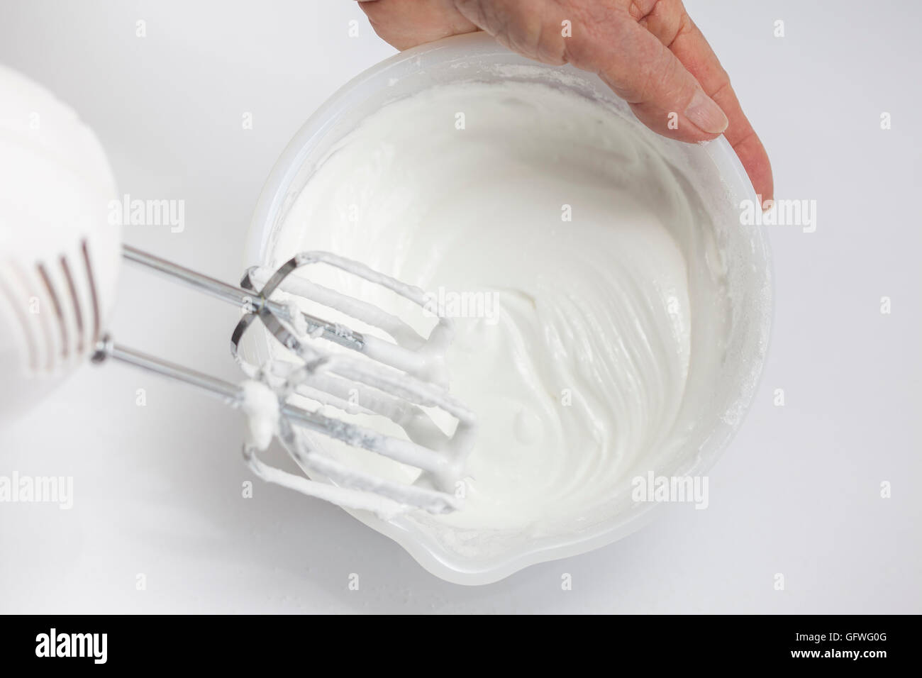 Egg whites snow in a white bowl Stock Photo - Alamy