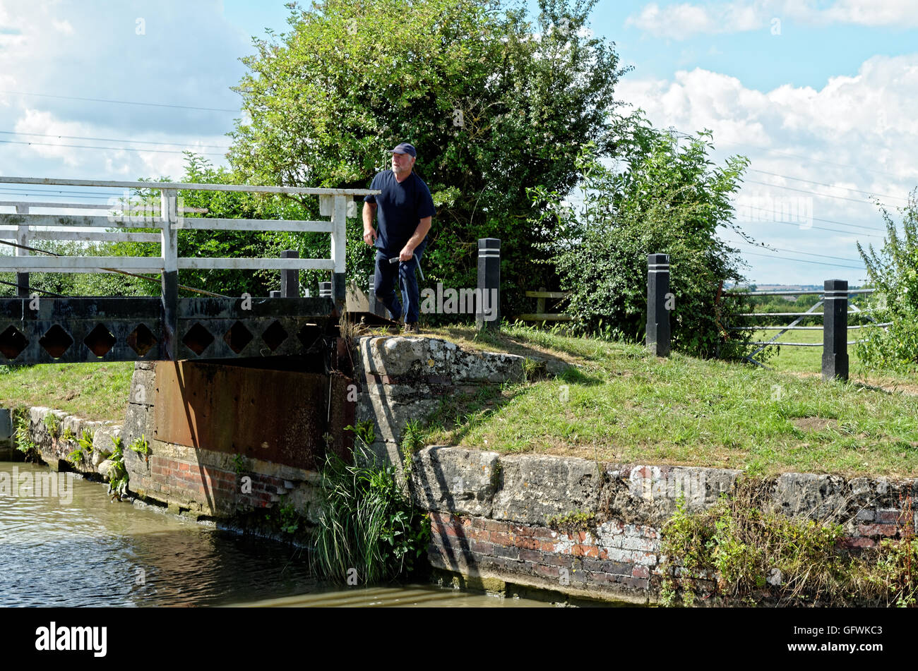 man operating swing bridge on canal Stock Photo - Alamy