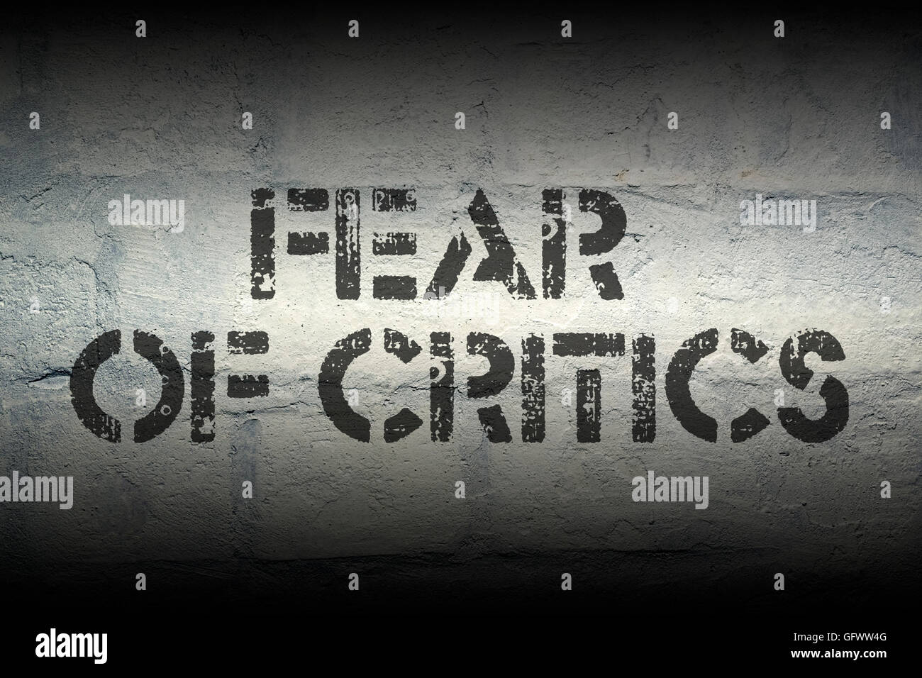 fear of critics stencil print on the grunge white brick wall Stock ...