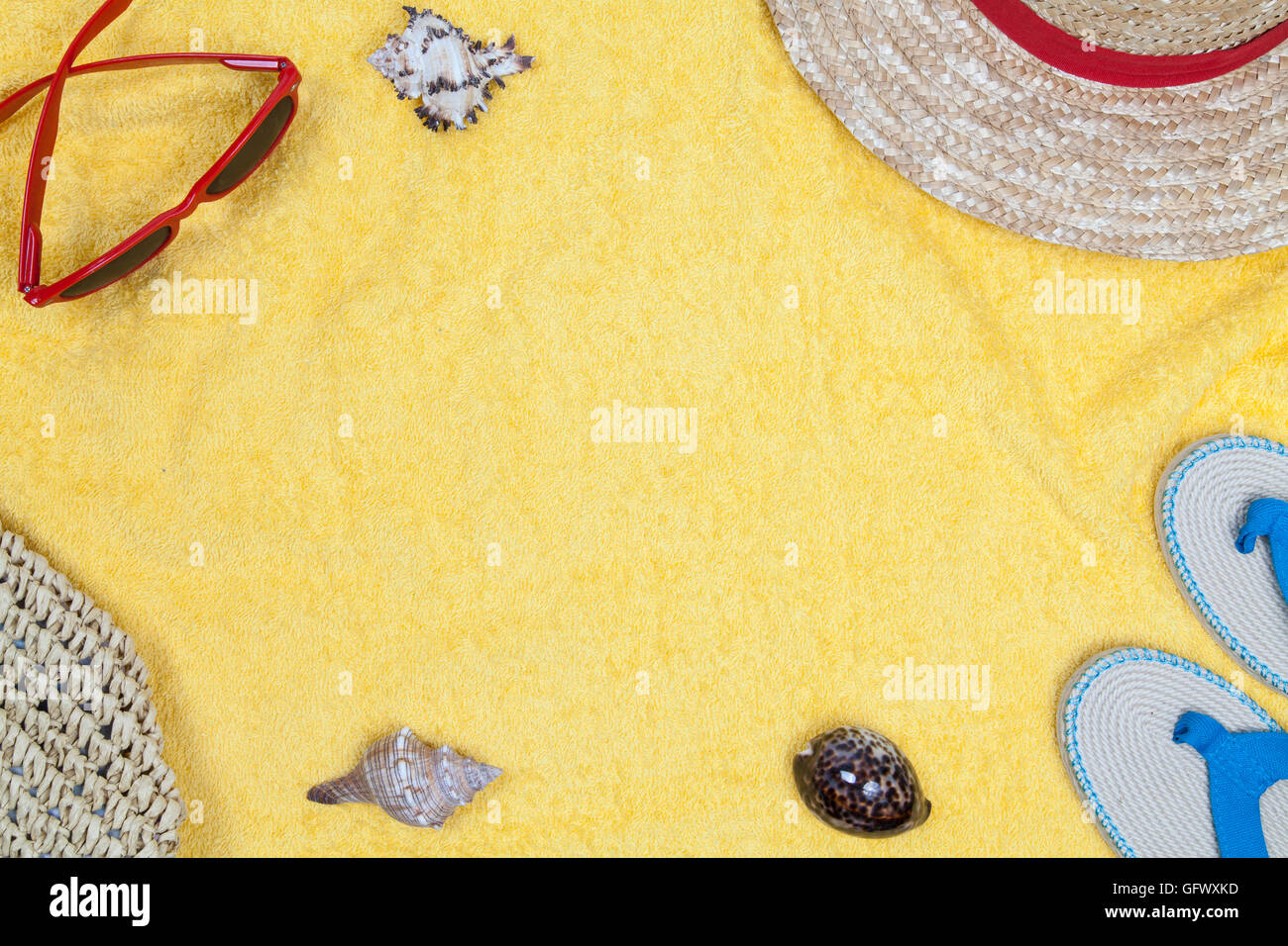 Yellow beach towel, some beach objects and space Stock Photo - Alamy