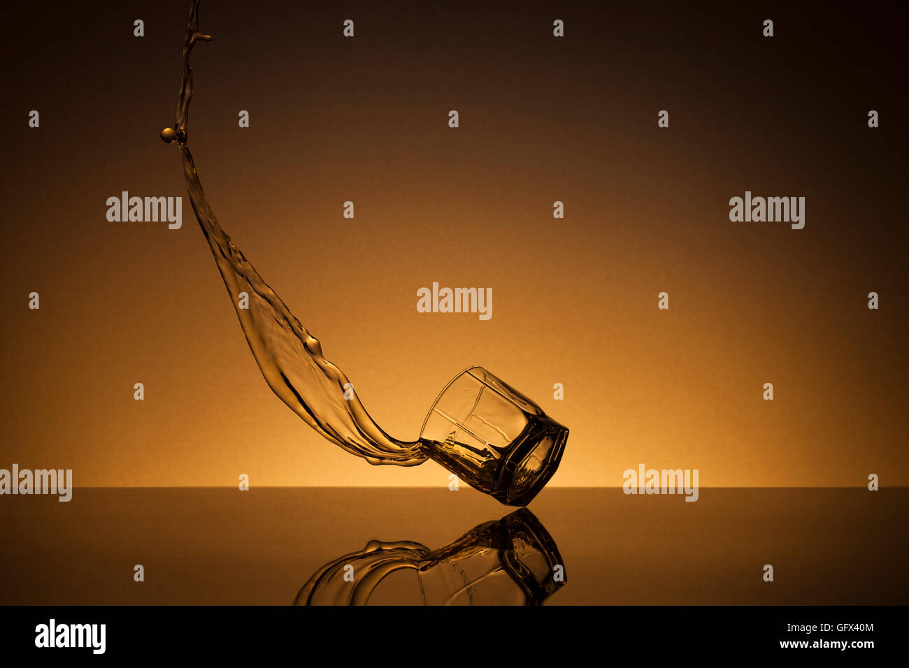 Falling glass of whiskey Stock Photo - Alamy