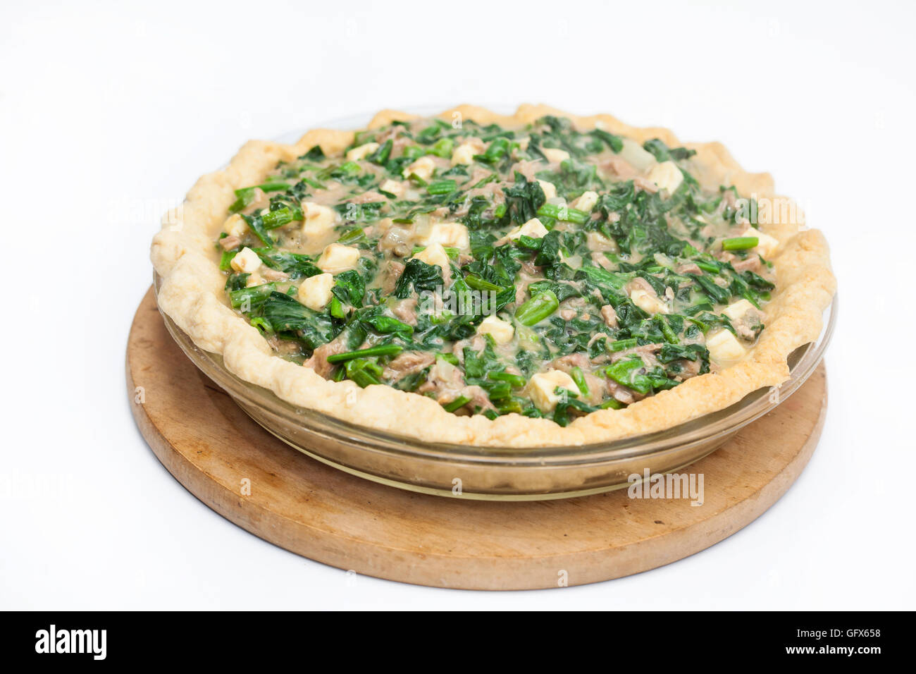 Raw filled spinach and tuna quiche lorraine Stock Photo - Alamy