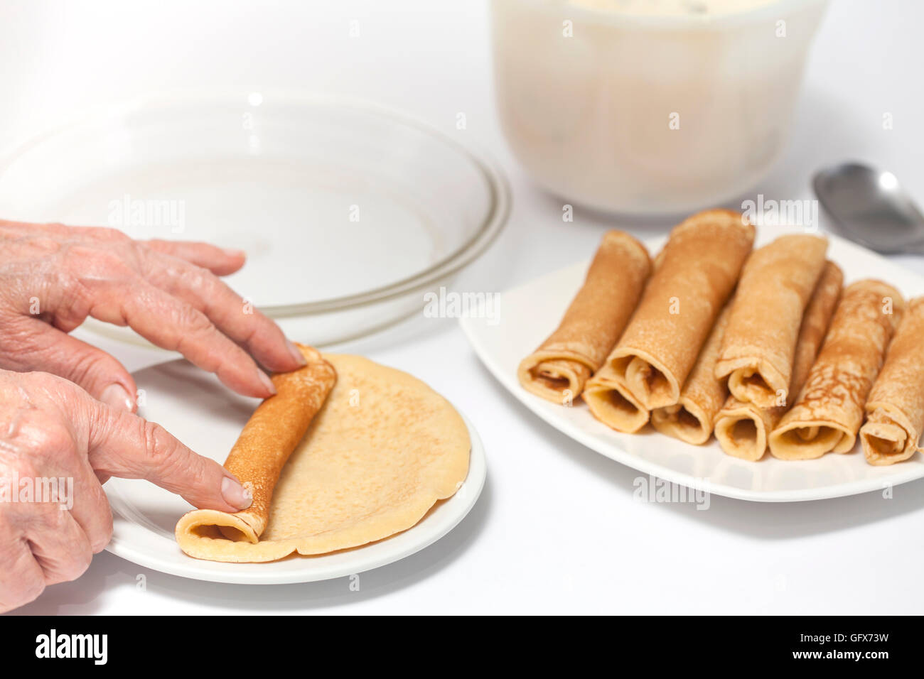 View of a woman hand rolling up a crepe Stock Photo - Alamy