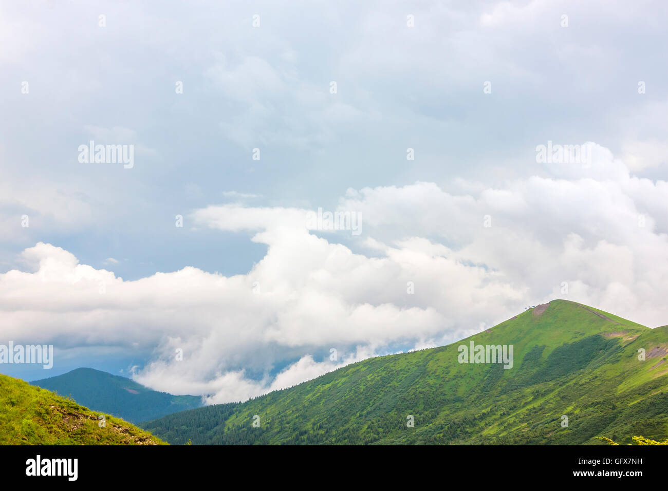 Sharp green mountain peaks and sky with dramatic clouds landscape Stock ...