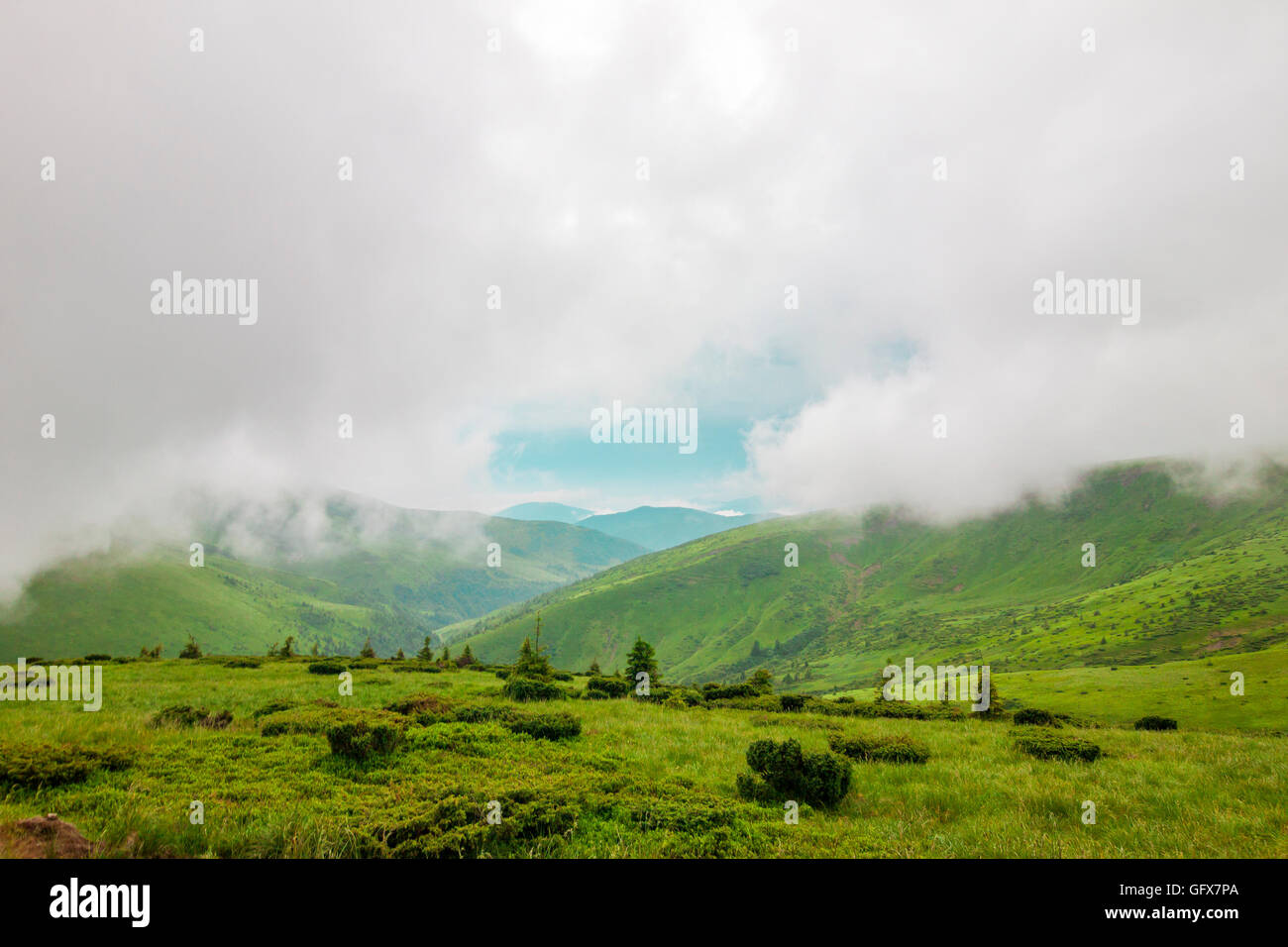 Sharp green mountain peaks and sky with dramatic clouds landscape Stock ...