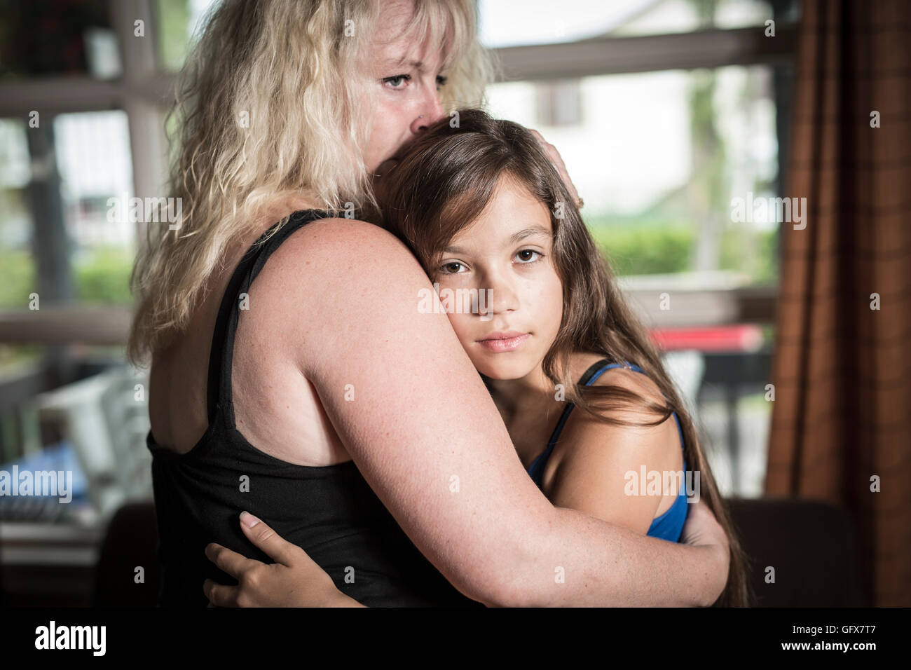 Mother hugging daughter crying hi-res stock photography and images - Alamy