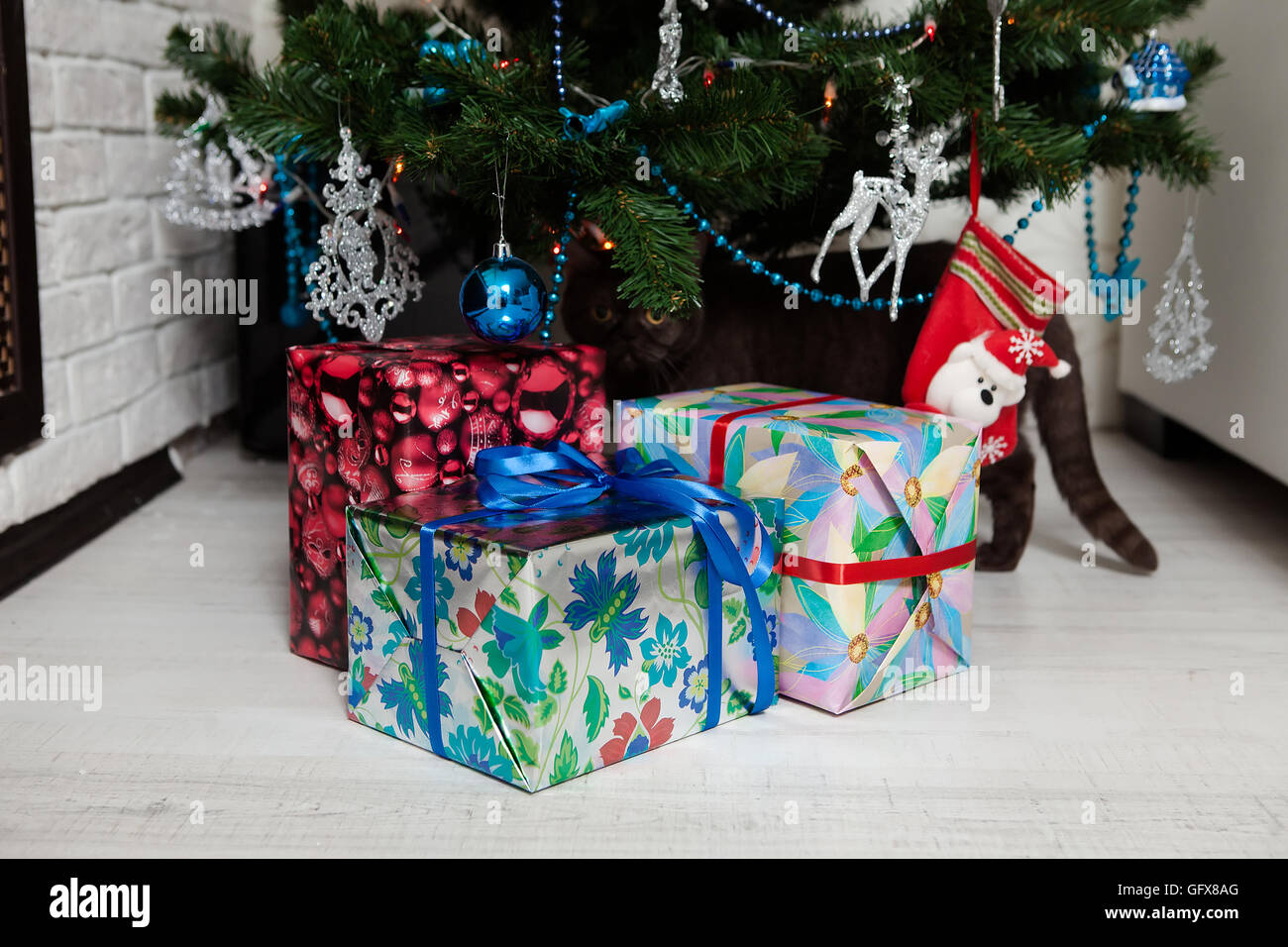 Cute Bengal Cat playing under the Christmas tree Stock Photo - Alamy