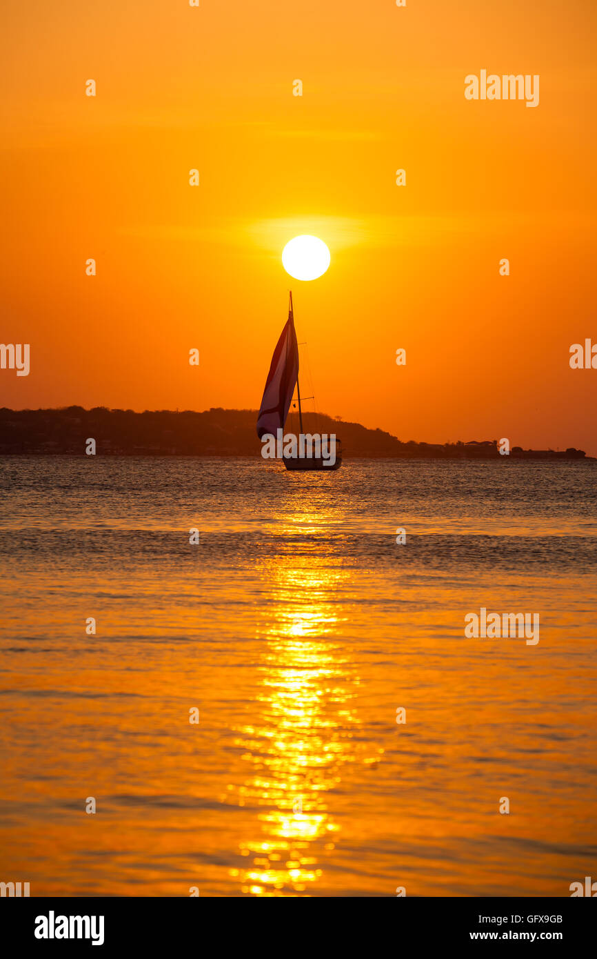 Sailboat at sunset Stock Photo - Alamy