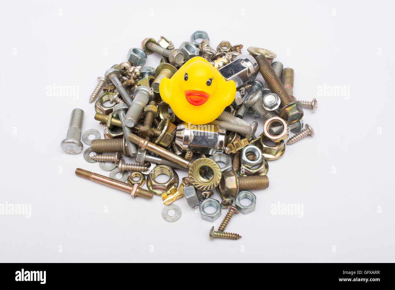 Yellow Duck Sitting on Bolts and Nuts - Hard Work Concept Stock Photo ...