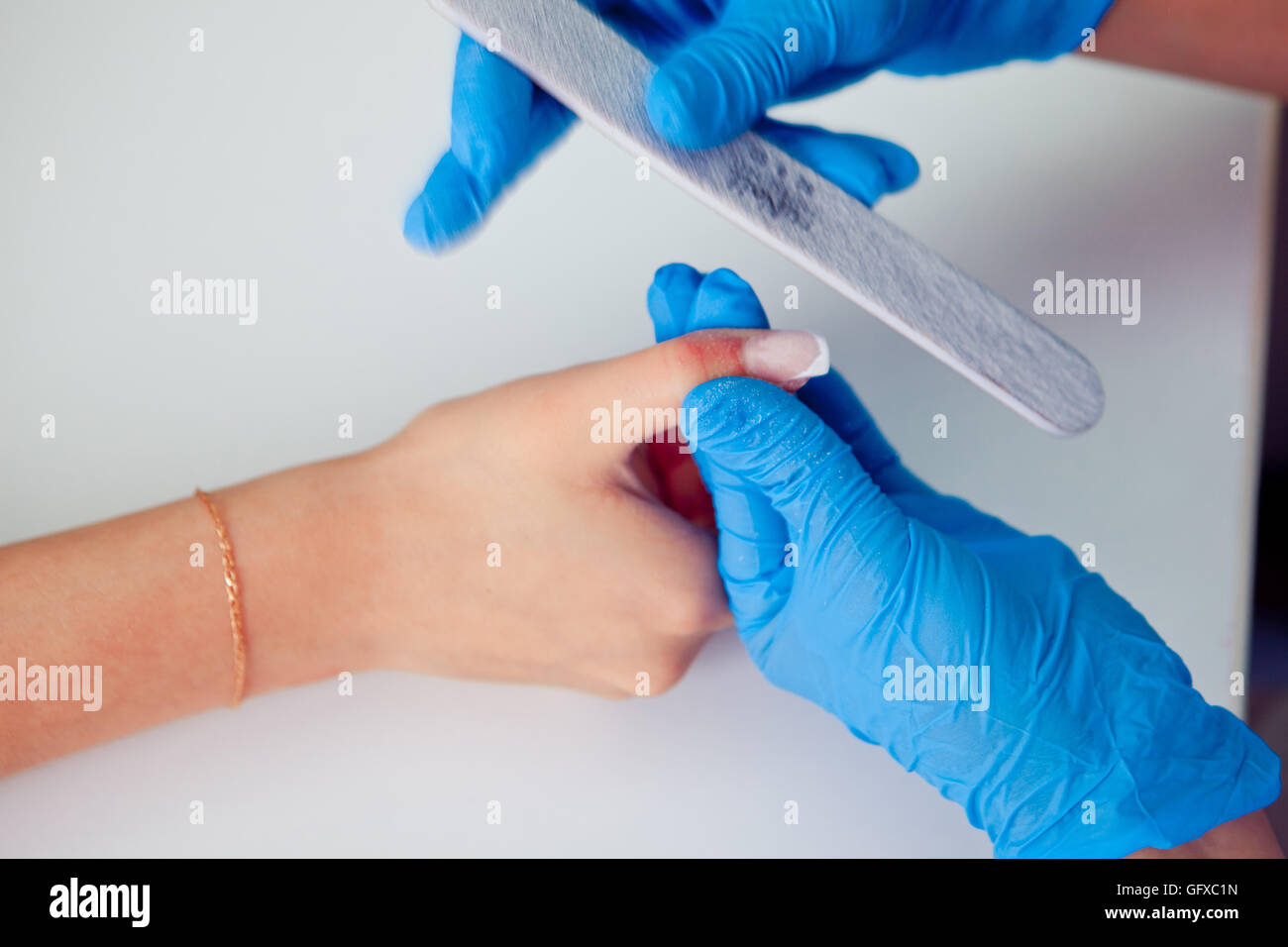 Woman with file filing nails,polishing , manicure Stock Photo - Alamy