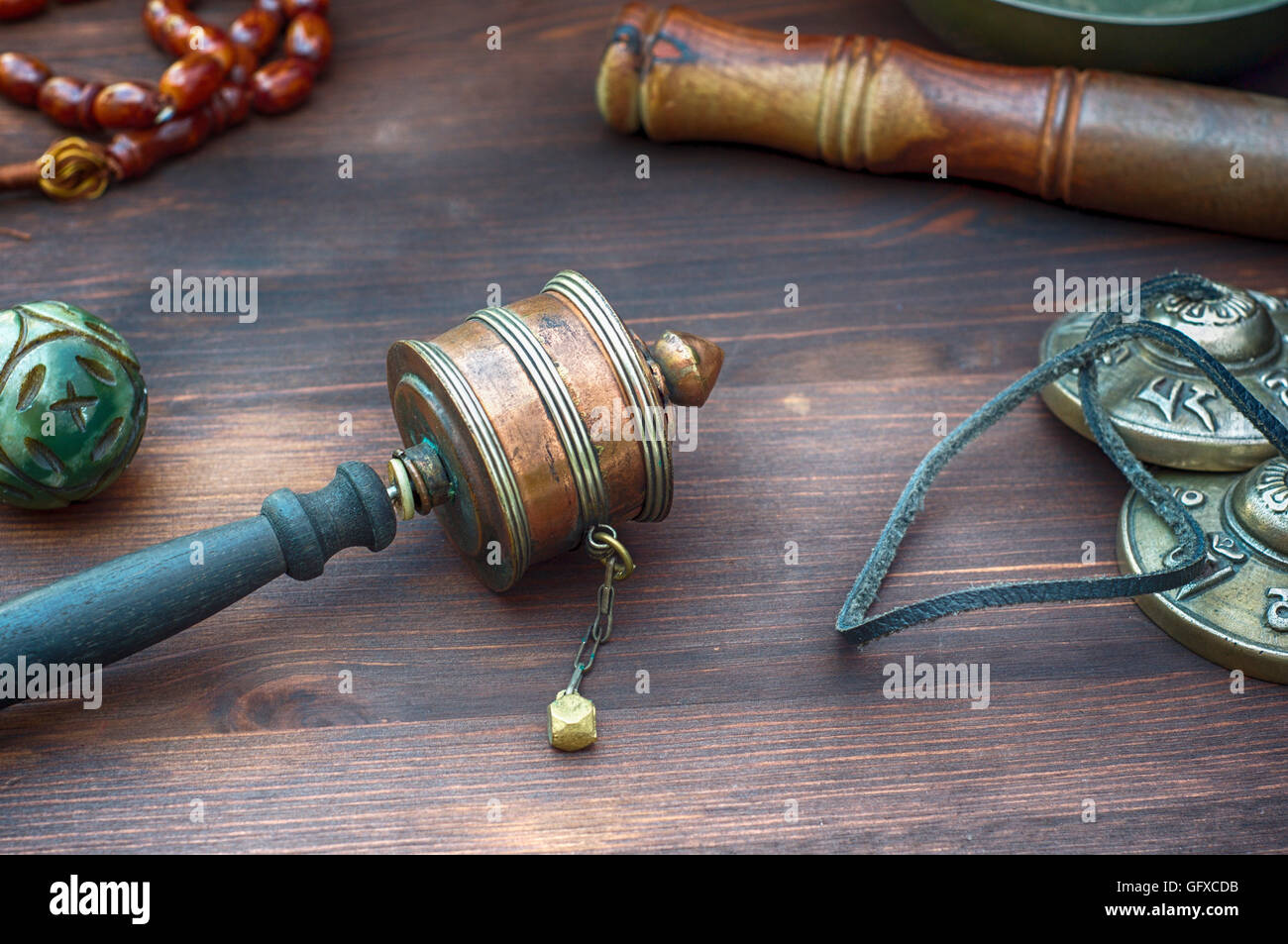 Hand prayer wheel among religious items on a wooden table Stock Photo ...