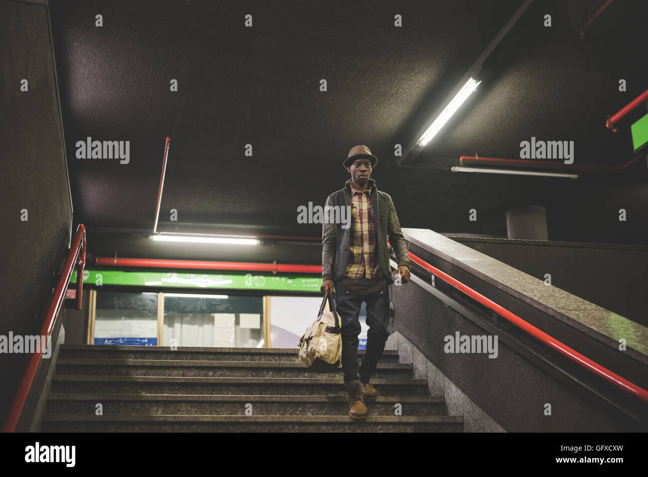 Young Handsome Afro Black Man Going Downstairs In The Underground young-handsome-afro-black-man-going-downstairs-in-the-underground