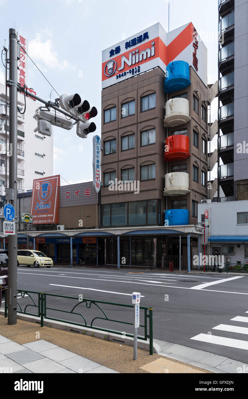 A tall building with balconies in form of huge colorful tea cups in ...