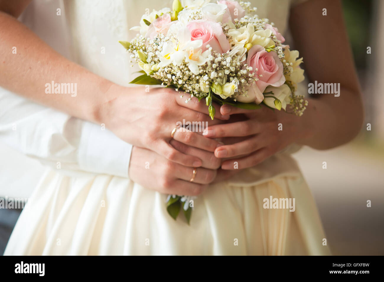 groom and bride holding wedding bouquet Stock Photo - Alamy