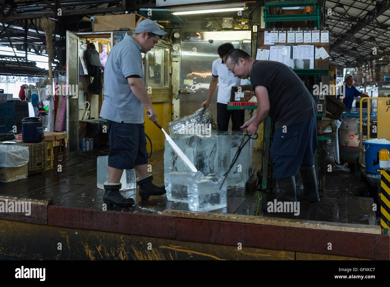 Workers cutting ice blocks with big saws at the tsukiji fish market in ...
